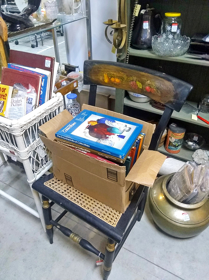 Collector guides stacked on a chair that's itself a collectible—the perfect meta-moment in an antique mall that rewards the observant shopper.