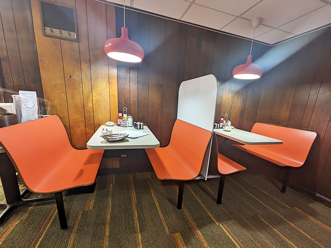 These vibrant orange booths have witnessed countless first dates, family celebrations, and regular Tuesday breakfasts over the decades.