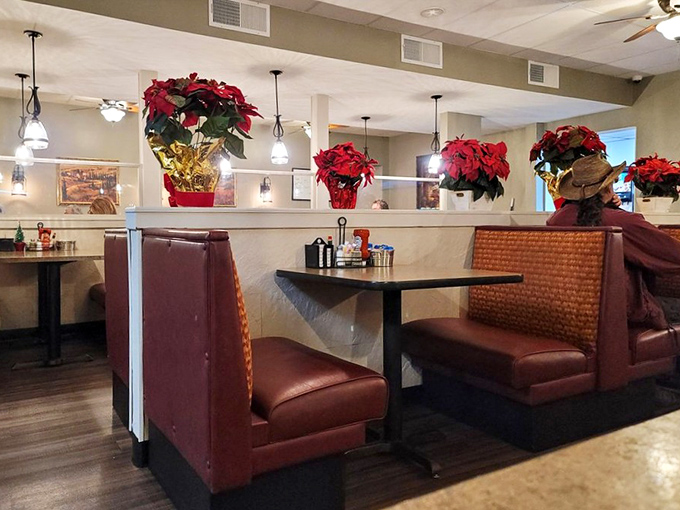 Booth seating adorned with festive poinsettias&mdash;comfort and joy served alongside your breakfast favorites. A cozy corner to start your day right.