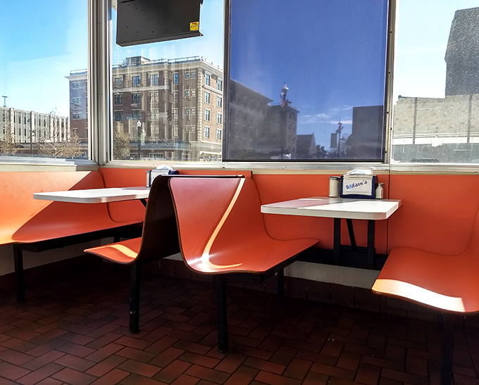 Those coral-colored booths frame Findlay's downtown like living paintings, turning lunch into an Edward Hopper scene with better food.