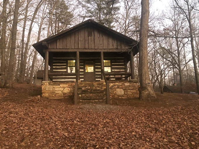 Autumn leaves carpet the ground around this rustic cabin, nature's way of rolling out the red carpet for weekend adventurers.