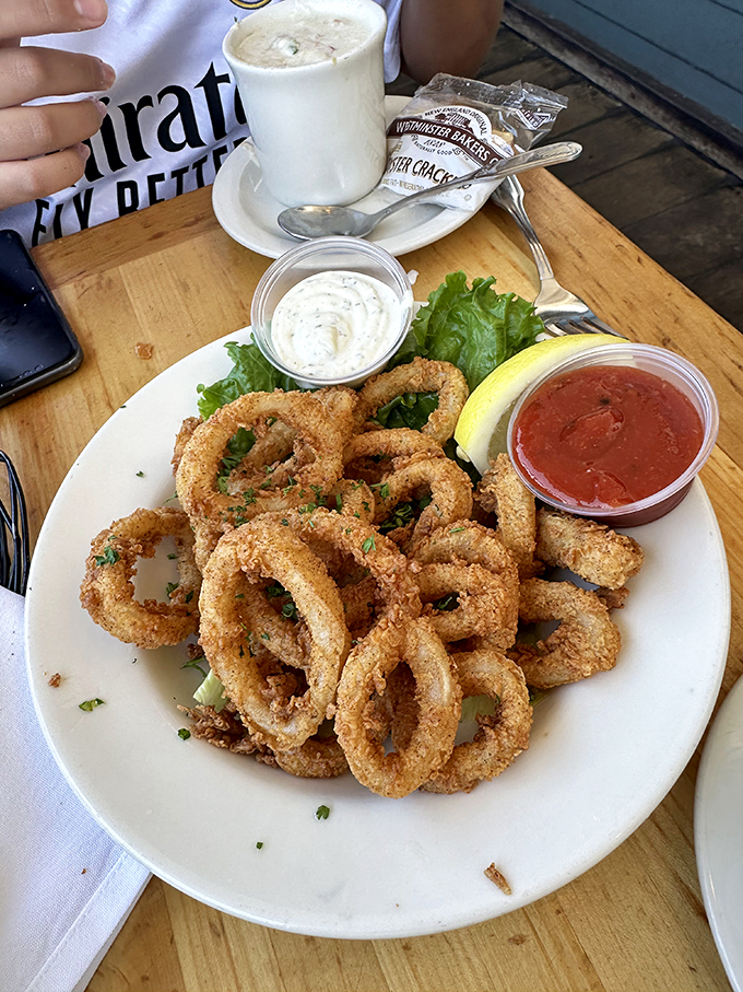 Calamari rings so perfectly golden they deserve Olympic medals. The dipping sauces are just showing off at this point.