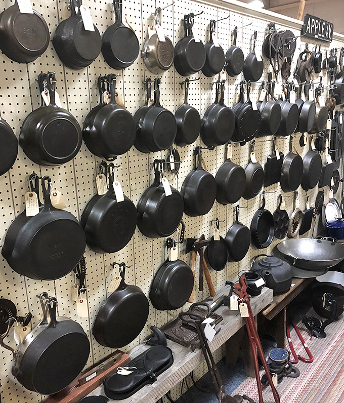 The cast iron wall of fame&mdash;seasoned with decades of family dinners. These pans have outlived the stoves they once sat upon.