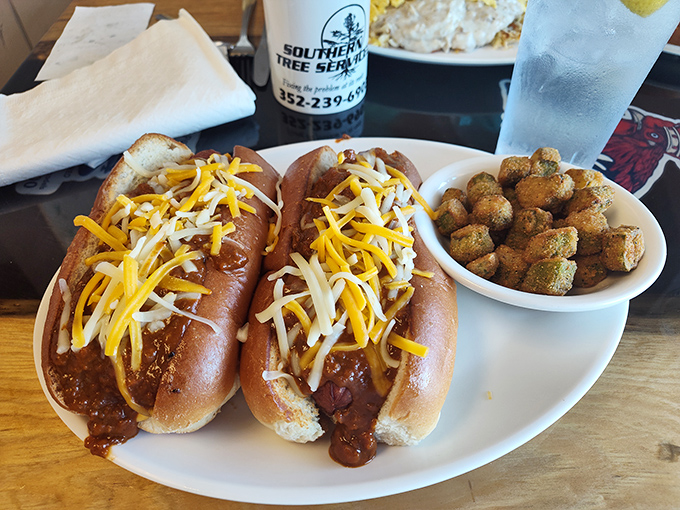 Chili cheese dogs topped with a snowdrift of shredded cheese—proof that sometimes the messiest foods are the most satisfying.