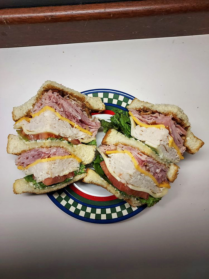 This club sandwich has more layers than your favorite drama series. A skyscraper of meat, cheese, and veggies that requires strategic bite planning.