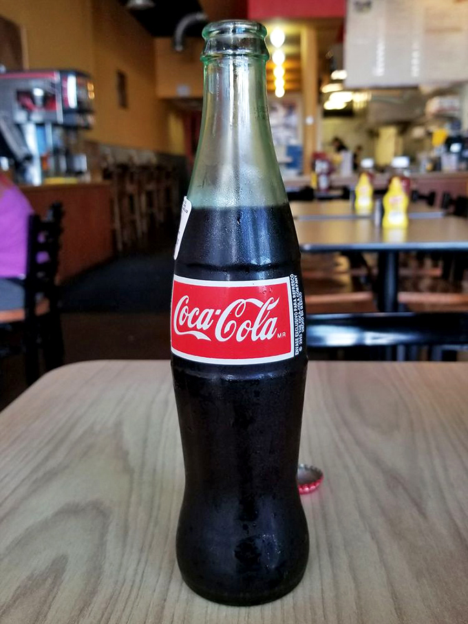 The iconic glass bottle Coca-Cola – because sometimes the perfect accompaniment to a great burger is a sip of carbonated nostalgia.
