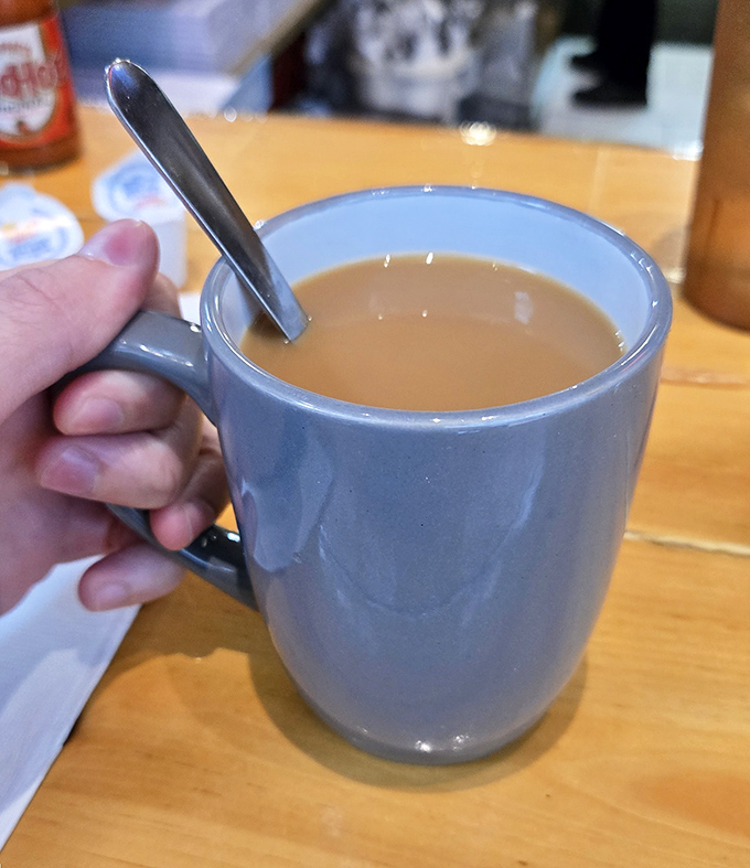 That perfect shade of coffee that promises to transform you from zombie to functioning human&mdash;liquid optimism in ceramic form.