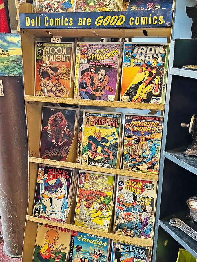 Comic book heaven under a vintage Dell sign. Spider-Man, Iron Man, and Silver Surfer waiting to be rescued by the right collector.
