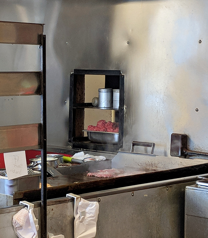 The well-seasoned grill where the magic happens&mdash;no fancy kitchen equipment, just decades of burger-making wisdom baked into every square inch.