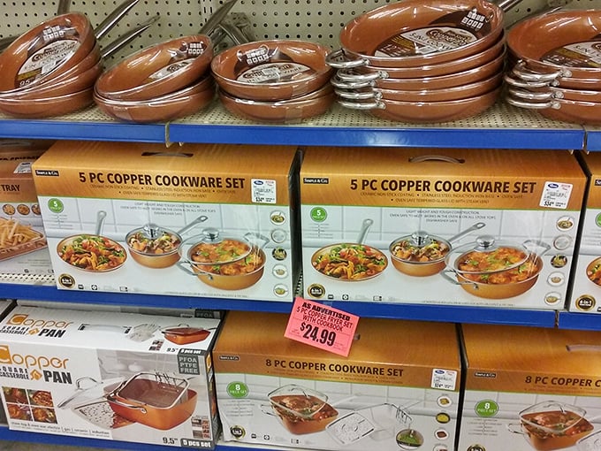 Copper cookware sets gleam under fluorescent lights, promising gourmet possibilities without the Williams-Sonoma price tag&mdash;culinary dreams within reach.