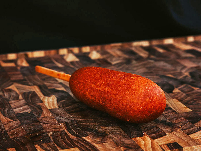 Not just any corn dog, but a perfectly golden specimen that elevates fair food to an everyday luxury worth the drive.