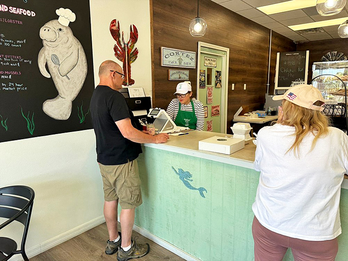 The counter where magic happens daily. That manatee illustration isn't just cute&mdash;it's watching to make sure you order dessert.