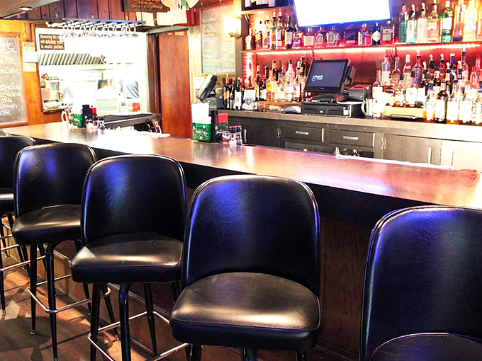 The bar isn't just stocked—it's a liquid library of possibilities, with comfortable stools that invite you to stay for "just one more."