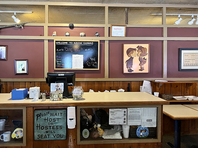 The welcoming host station, complete with that charming "Please Wait" sign that's been politely asking for patience since before TikTok was a thing.