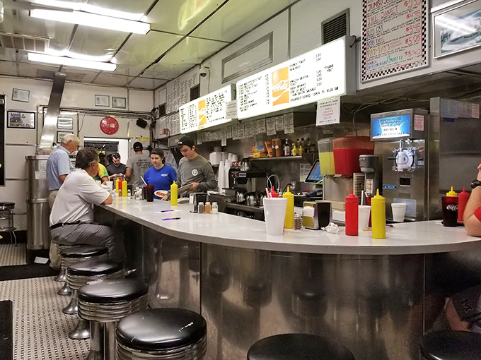 The counter where burger magic happens. Watch the choreography of short-order cooking at its finest.