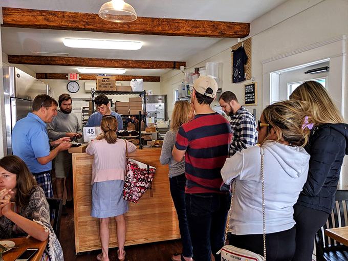 The counter buzzes with anticipation as customers debate between impossible choices in this carbohydrate wonderland paradise.