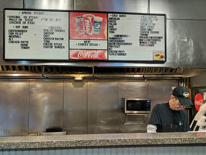 Behind the counter, where sandwich dreams become reality. That menu board has likely witnessed thousands of "mmm" moments.