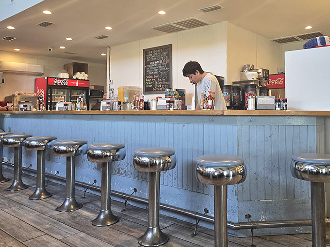 Classic diner counter seating&mdash;where solo travelers become temporary locals and the coffee refills come with a side of community.