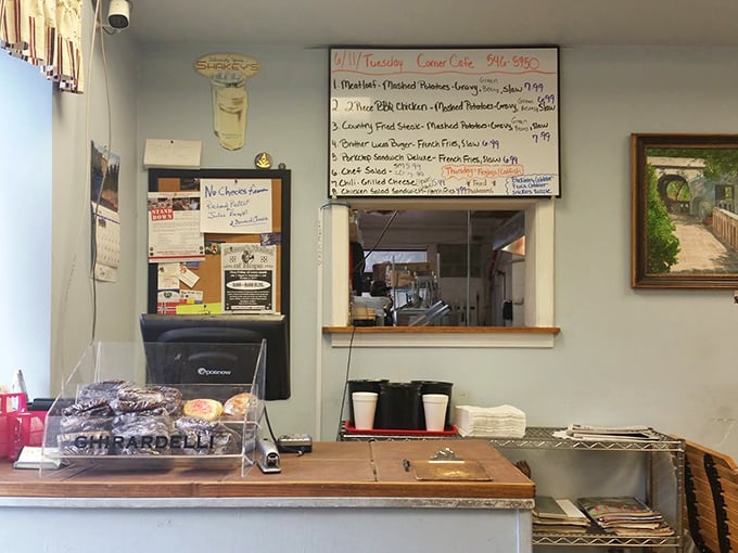 The order counter&mdash;where dreams are placed and magic begins. That whiteboard menu is a roadmap to satisfaction.