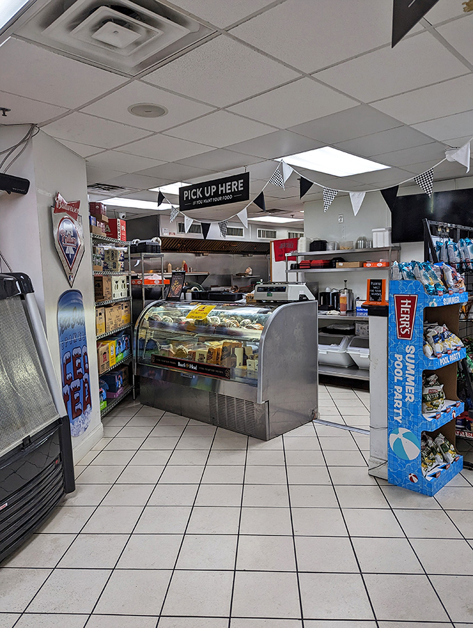 Where the magic happens: the pickup counter, adorned with checkered pennants like a finish line for your hunger race.