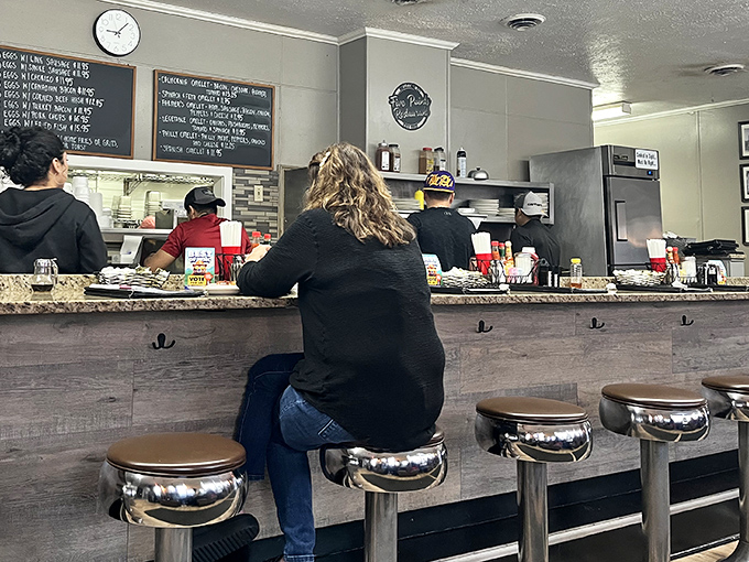 Where breakfast magic happens. The counter view offers dinner theater starring short-order cooks who can flip eggs faster than politicians flip positions.