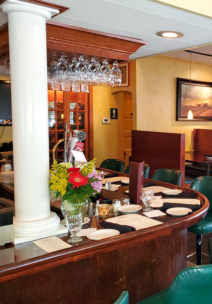 The bar area's polished wood and hanging glassware create the perfect stage for the cocktail theater about to unfold in your glass.