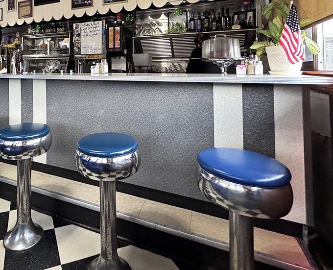 Counter seating: where the real diner magic happens. These chrome and blue stools have witnessed first dates, business deals, and countless regulars starting their day right.