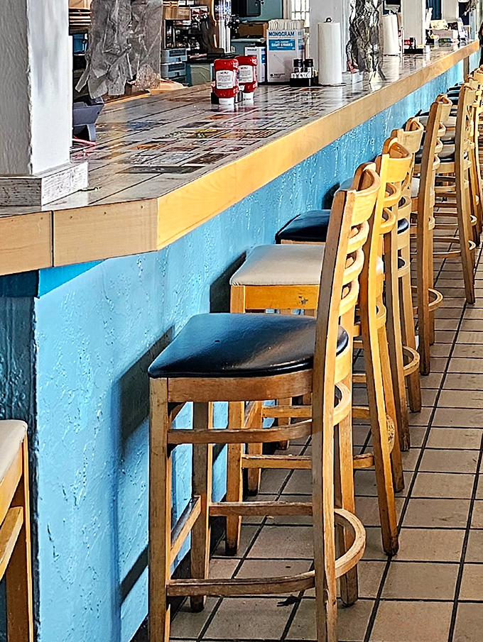 Bar seating with a turquoise base that matches the ocean's mood on a perfect beach day.