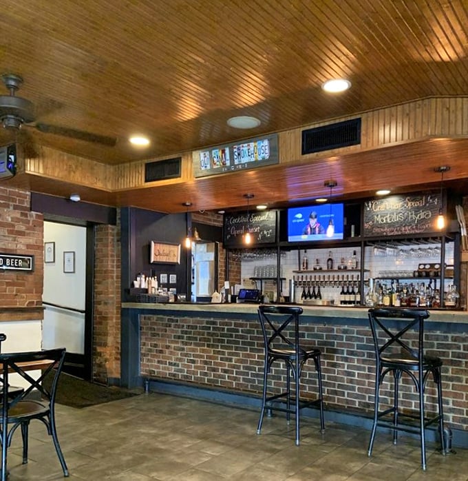 The bar area whispers promises of cold drinks and good times, with wooden accents that echo the smokehouse aesthetic throughout.