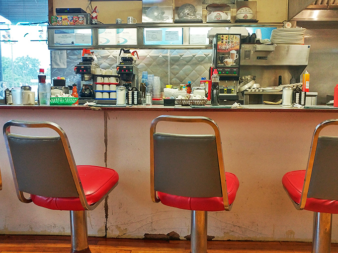 Those red vinyl counter stools have witnessed countless morning conversations, first dates, and hungover Sunday recoveries.