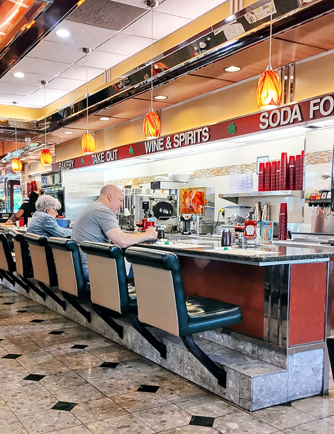 Counter seating: where solo diners become temporary family and the kitchen's symphony plays just for you. Front-row seats to breakfast theater.