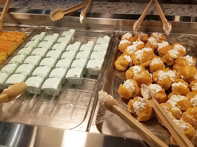 Mint-green puddings neighbor cream puffs topped with whipped cream&mdash;proof that at Waha, the sweet finale gets the same attention as the main event.