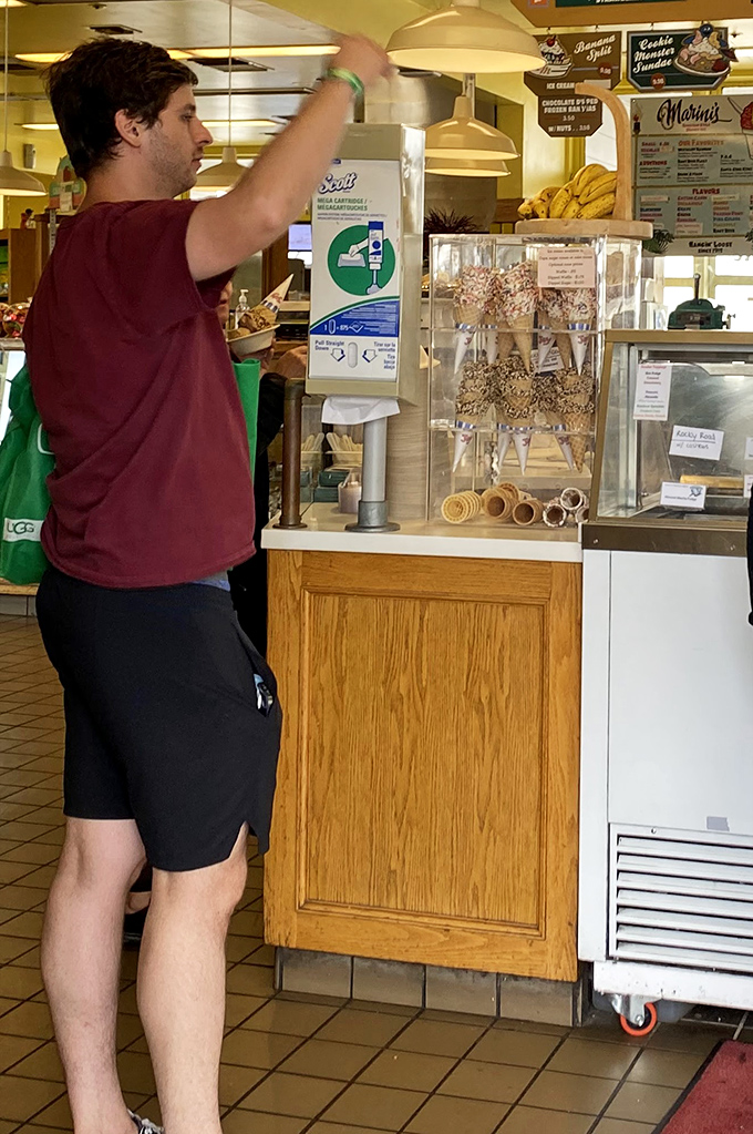 The man contemplating his candy choices is all of us—paralyzed by the beautiful dilemma of too many perfect options.