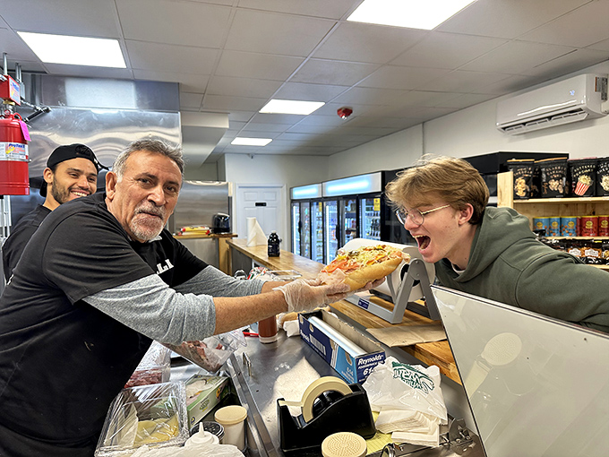 The sandwich handoff &ndash; a moment of pure anticipation. The exchange between maker and eater is the prelude to deliciousness.