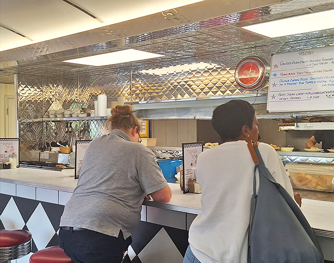 The counter experience: where strangers become temporary neighbors and the kitchen symphony plays its delicious music just feet away.