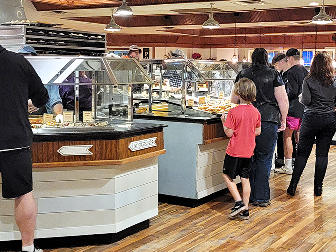 Families line up with the universal look of buffet anticipation&mdash;that gleeful "I'm about to try everything" expression that crosses all age boundaries.
