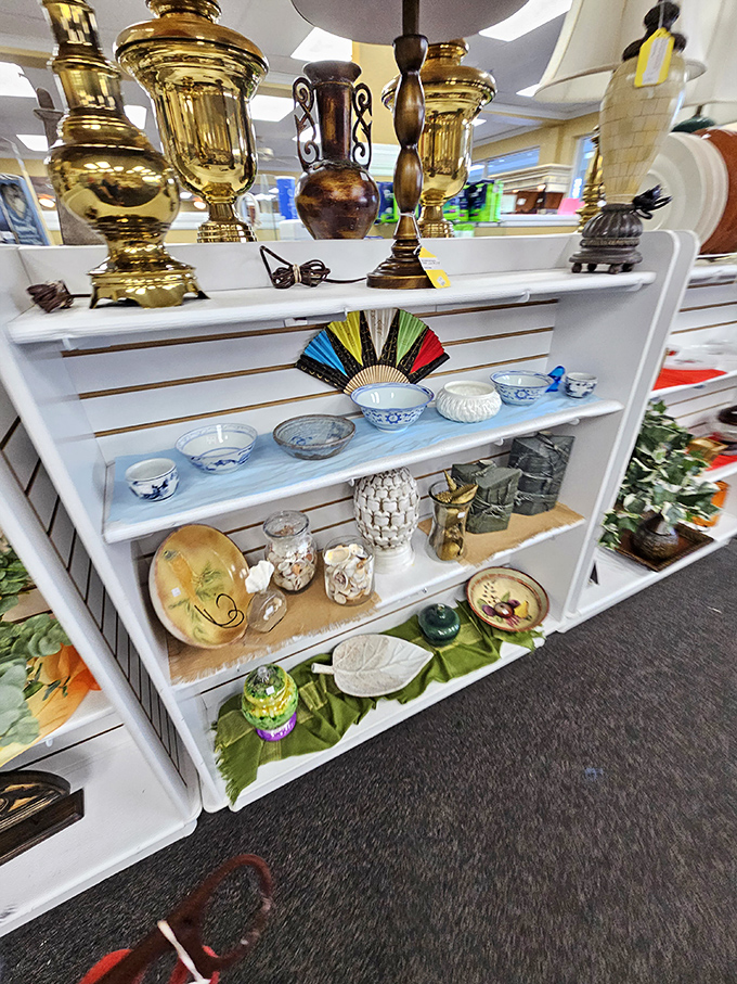 Home d&eacute;cor that spans decades and styles. Those wooden shelves against mint green walls create a display worthy of an upscale boutique.