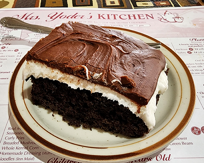 A slice of chocolate cake with cream filling that makes you question why you ever wasted time on lesser desserts.