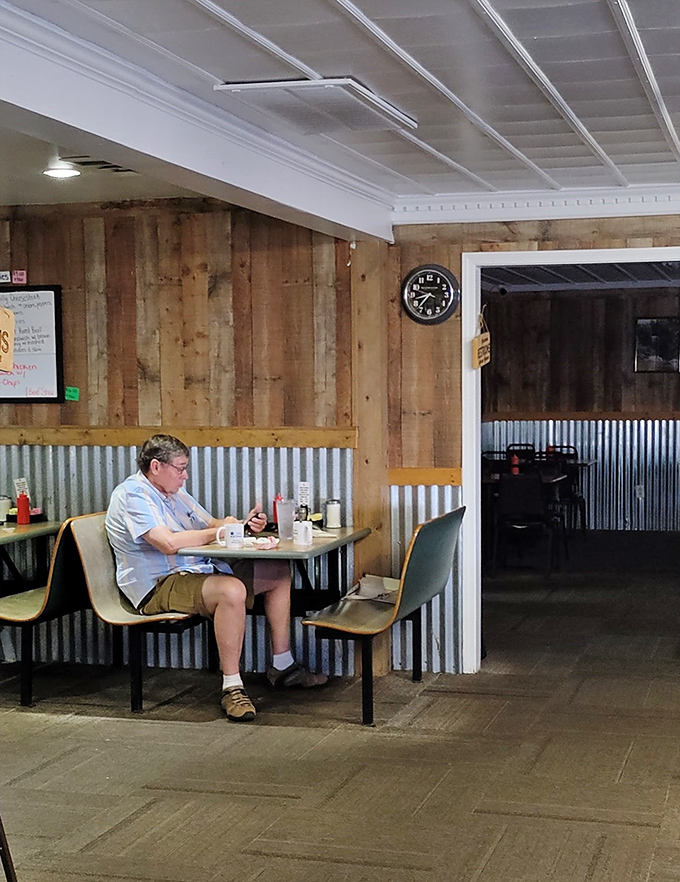 Rustic wood paneling meets corrugated metal in a dining space that feels like Tennessee's version of a cozy cabin.