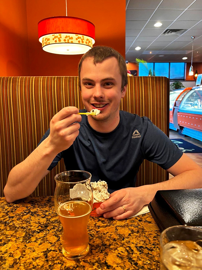 Pure joy captured mid-bite - this is exactly how calamari should make you feel.