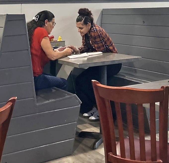 The booths offer just enough privacy for intimate conversations or plotting your next food selection. Strategic dining at its finest.