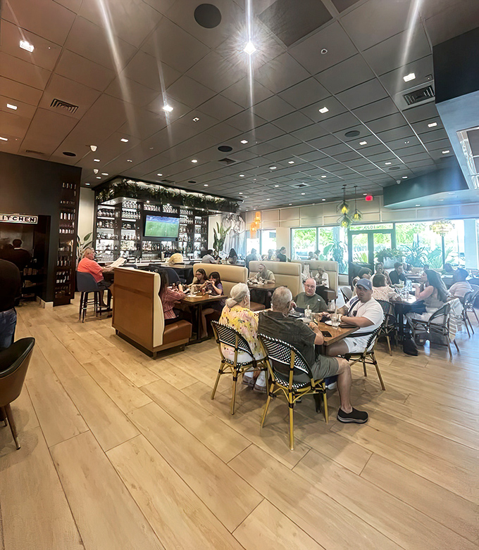 Diners enjoying the warm wood tones and airy atmosphere—notice how nobody's checking their phones? That's the power of good food.