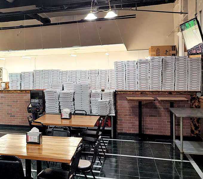 Empty pizza boxes stacked like trophies of deliciousness. In the pizza world, this is what success looks like on a busy night.
