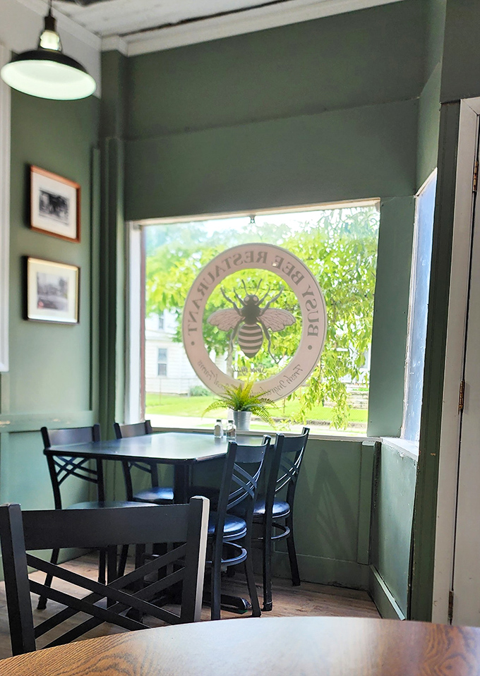 The dining area's soft green walls and bee logo create that "welcome home" feeling. Even the light seems to say, "Stay awhile, order dessert."