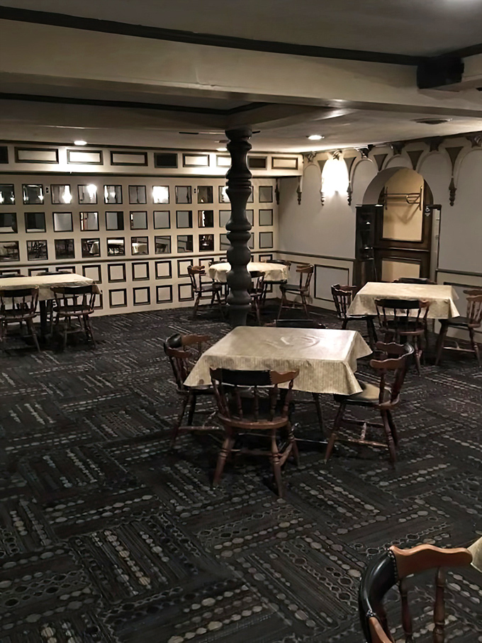 The main dining area showcases rustic elegance with its soaring ceiling, chandelier, and walls decorated with local memorabilia.