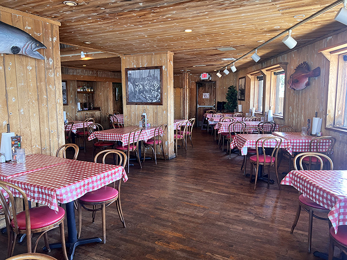 The dining room feels like the captain's quarters of a beloved ship, where every red-checkered table holds the promise of seafood memories in the making. 
