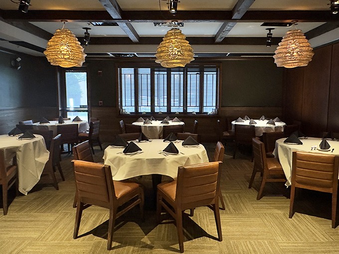 White tablecloths and distinctive pendant lighting create dining spaces that feel both intimate and spacious&mdash;like your fancy living room, if you actually used it.