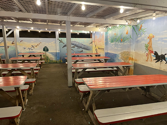 Evening light filters through the dining area, illuminating murals of ocean life. Even the walls here tell stories of the sea.