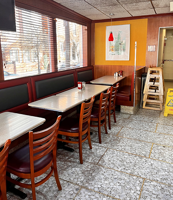 Sunlight streams through the windows, illuminating a quiet corner where countless newspapers have been read and coffee cups refilled throughout the decades.