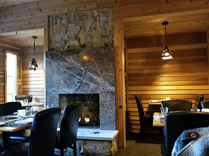 Rustic wood meets elegant stone in this fireplace dining area. Somehow both presidential lodge and Italian countryside at once. 